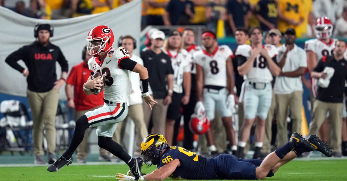 Michigan fans strike surrender cobra poses before halftime vs. Georgia ...