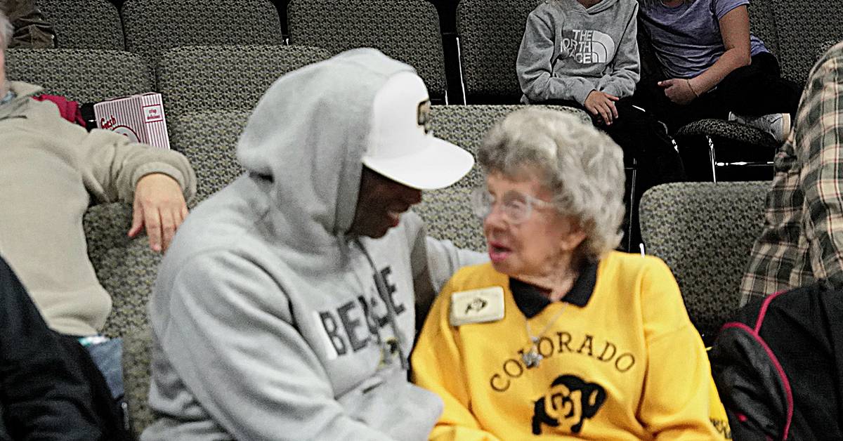 Coach Prime shares moment with 98-year-old CU mega fan Peggy Coppom at ...