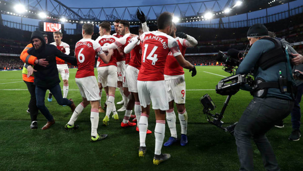 Arsenal to issue lifetime ban to pitch invader who touched Smalling ...