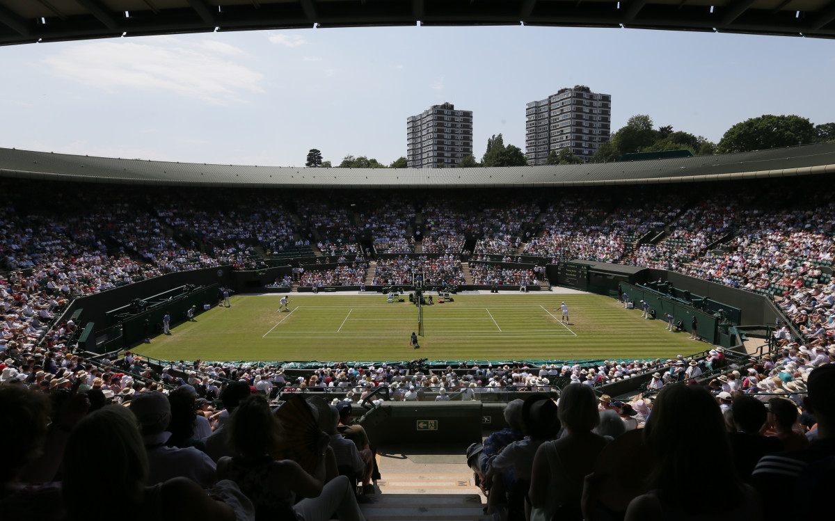 The Latest: Wimbledon gets its first taste of rain - Sports Illustrated