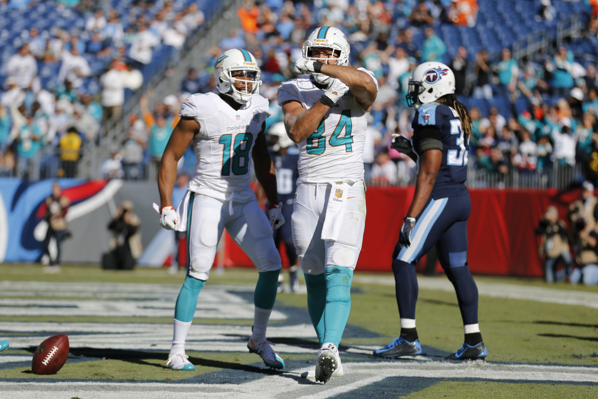 Dolphins rout Titans 38-10 in Dan Campbell's coaching debut - Sports ...