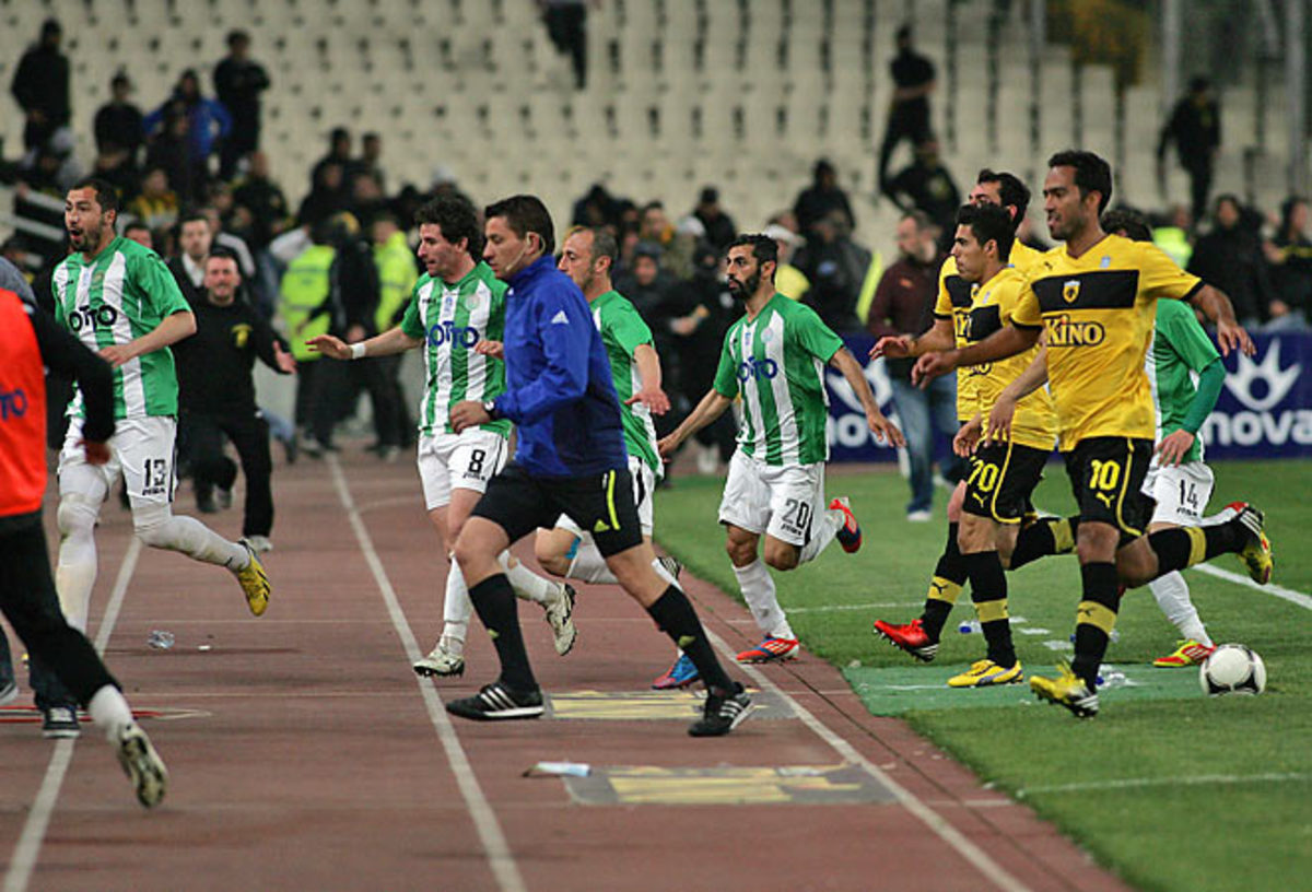 AEK Athens players chased off pitch by angry fans - Sports Illustrated